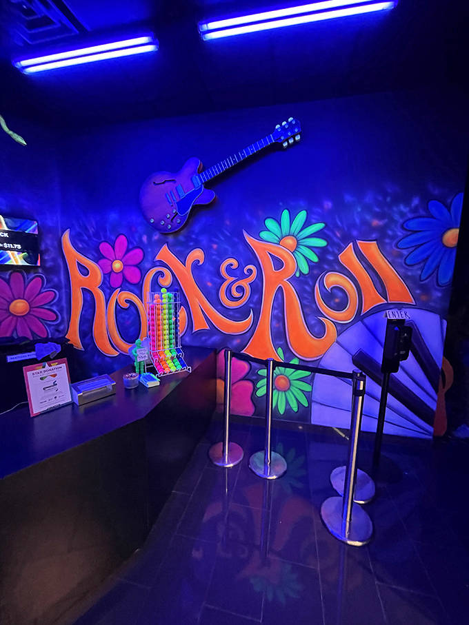 The check-in counter glows with retro flower power vibes that would make both Woodstock attendees and 80s mall rats feel right at home.