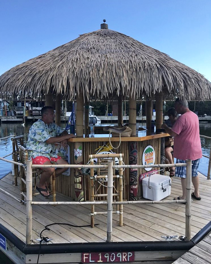The "Creaky Tiki" welcomes a group of friends celebrating with colorful canned beverages – the perfect floating party platform.