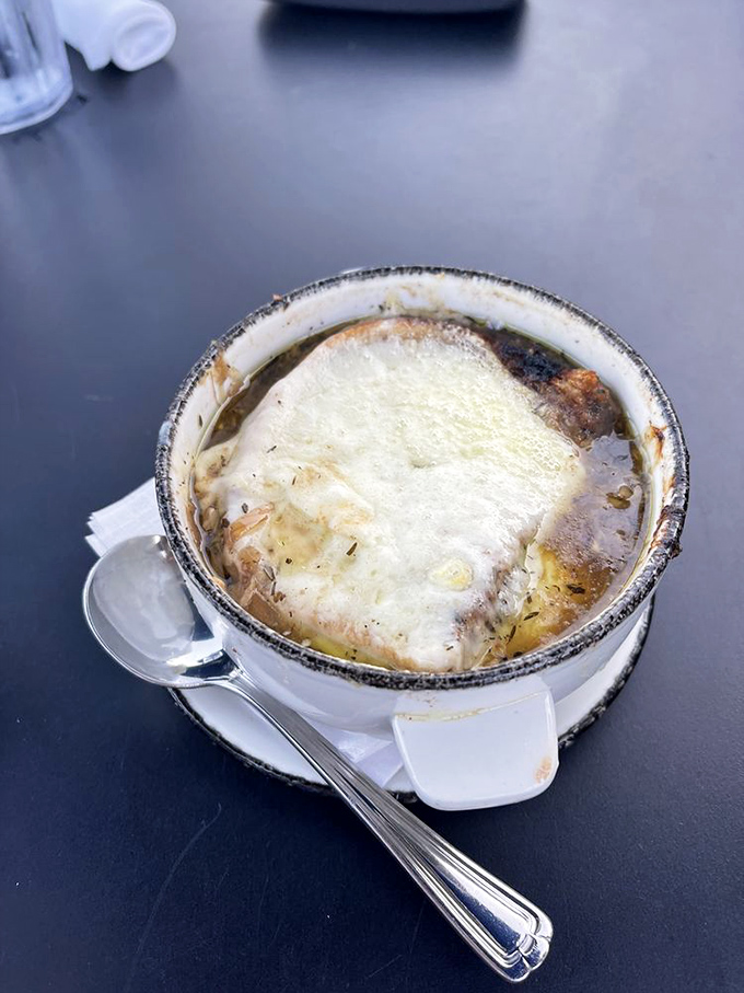 French onion soup crowned with a magnificent cheese canopy that stretches dramatically with each spoonful, comfort in a crock that's worth the inevitable cheese pull photo.
