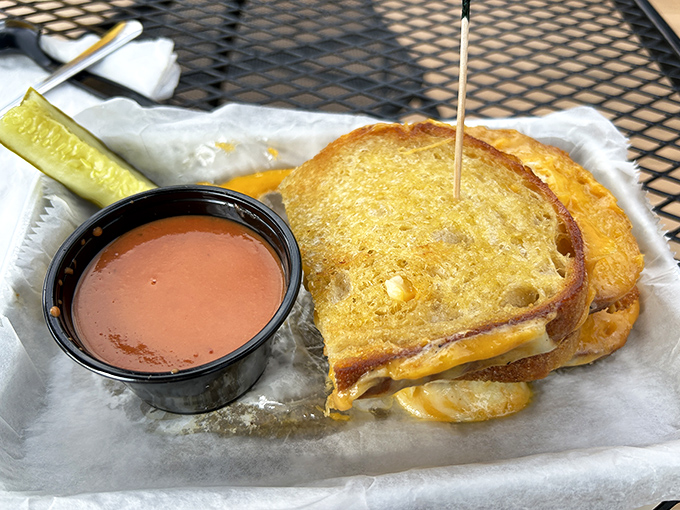 The grilled cheese transcends childhood memories &ndash; perfectly toasted bread embracing melted cheese with tomato soup for essential dipping.