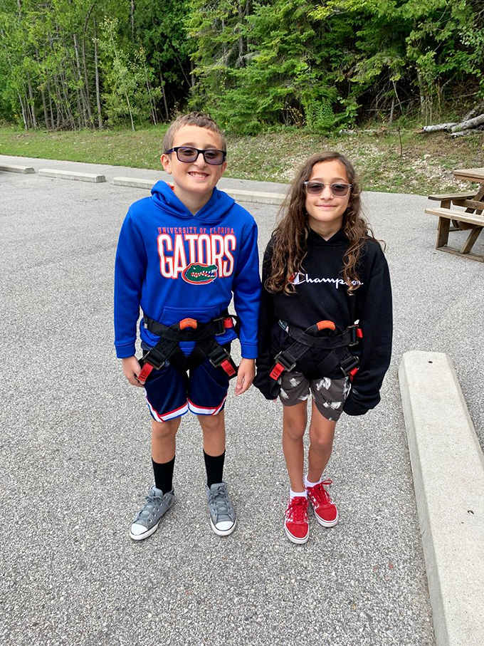 Adventure-ready kids sport safety harnesses and excited grins, preparing for whatever gravity-defying challenges await them next.