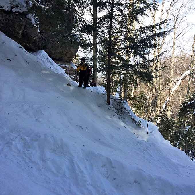 Nature's ice sculpture garden clings to rocky outcroppings, where water's patient journey creates magnificent frozen architecture.
