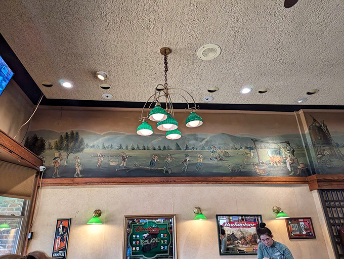 Whimsical leprechaun murals wrap around the upper walls, depicting mischievous little folk engaged in various beer-related activities with folksy charm.