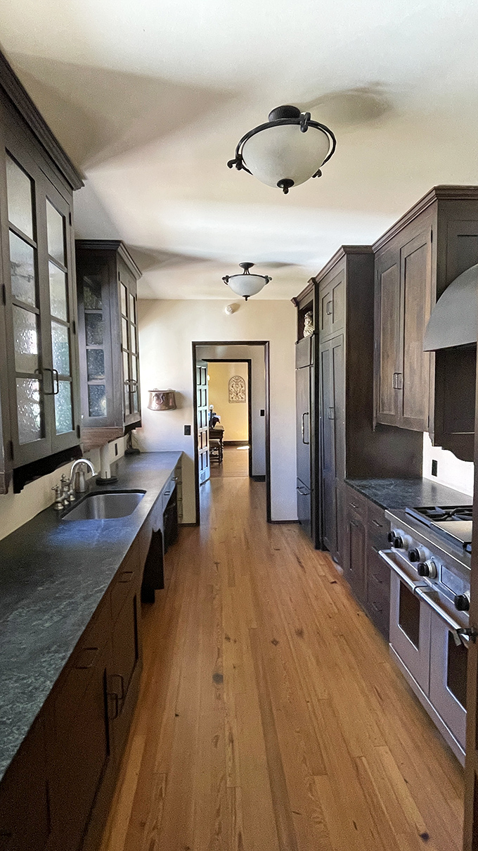 The kitchen blends period charm with functional updates, proving you can honor history without sacrificing the ability to actually cook a decent meal.