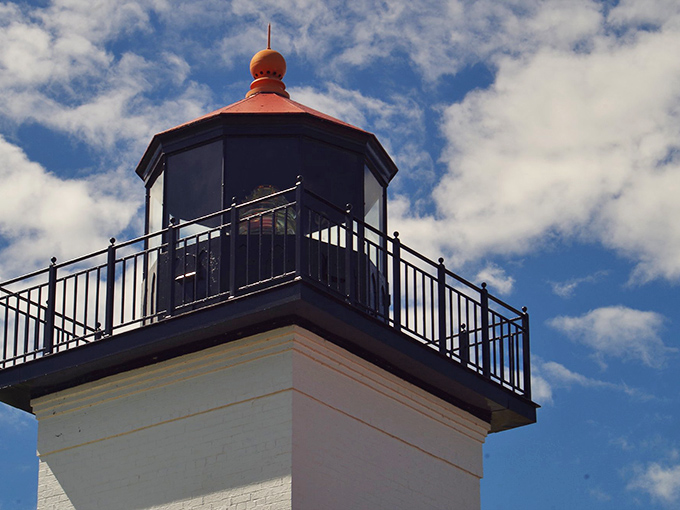 The light tower reaches skyward like an architectural exclamation point, its red cap visible to ships miles from shore.