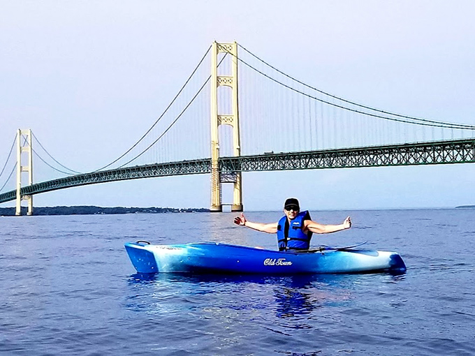 A kayaker gains a unique perspective of the Mighty Mac, where the bridge's 552-foot towers dwarf even the most adventurous visitors.