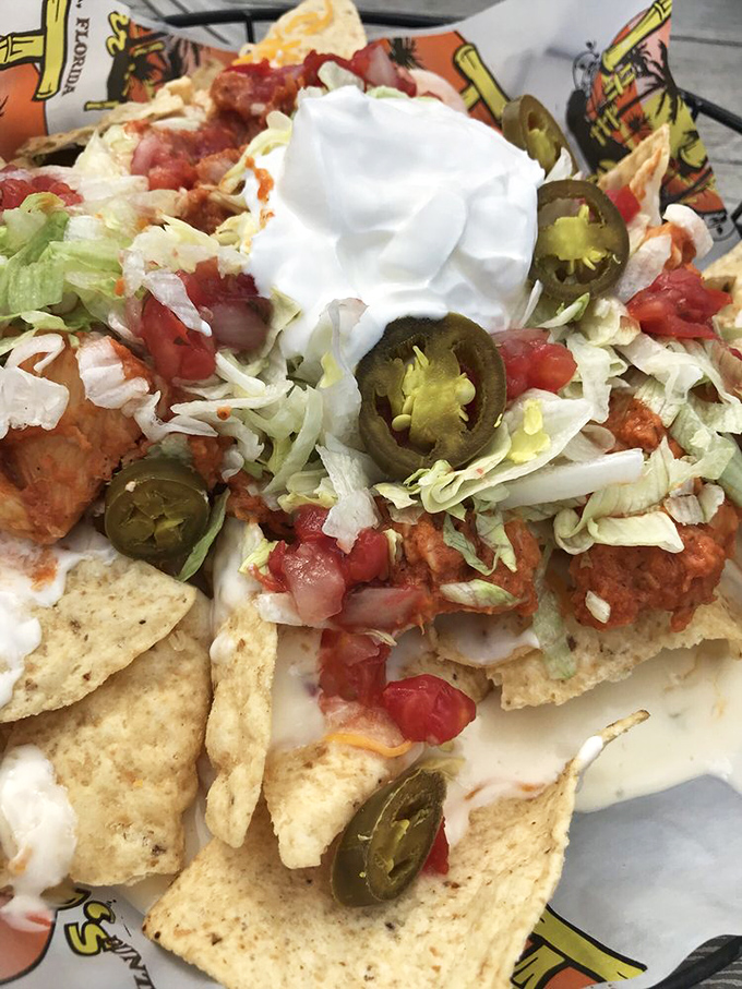 These aren't your average ballpark nachos. Loaded with jalape&ntilde;os, sour cream, and enough toppings to require a structural engineer's approval.