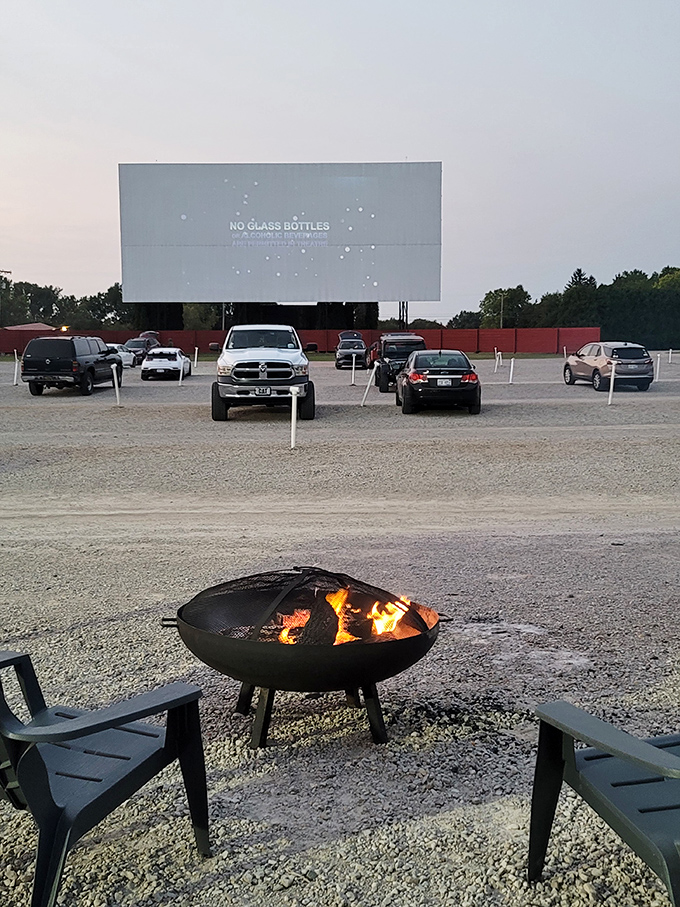 Nature's ceiling meets Hollywood magic as the outdoor screen glows against the darkening sky, cars positioned for optimal viewing pleasure.