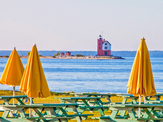 Those yellow umbrellas aren't just saying "picnic spot" &ndash; they're practically shouting "best lighthouse viewing area with bonus snack potential!"