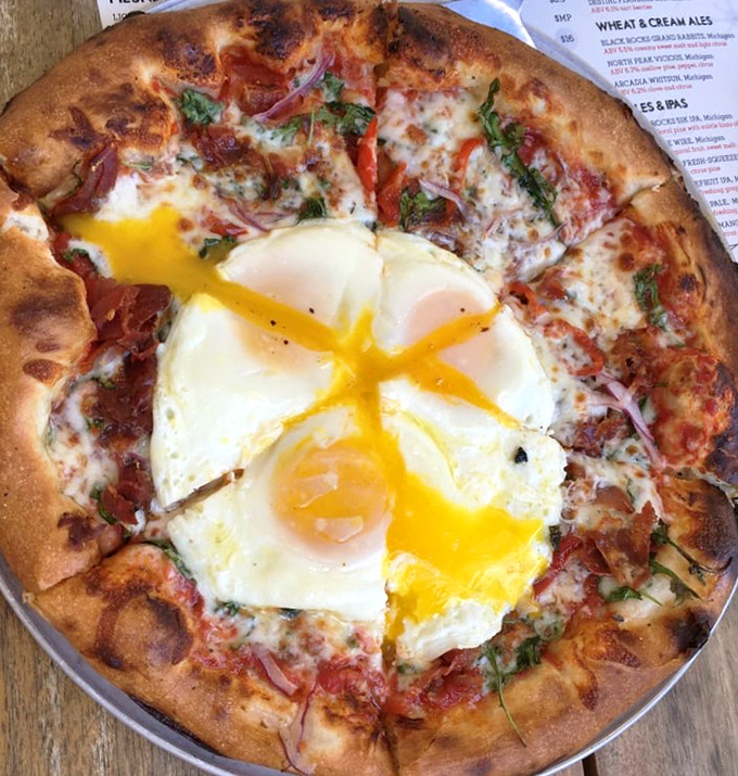 The runny egg pizza &ndash; where breakfast meets dinner in a cosmic collision of flavors that will make you question conventional meal boundaries.