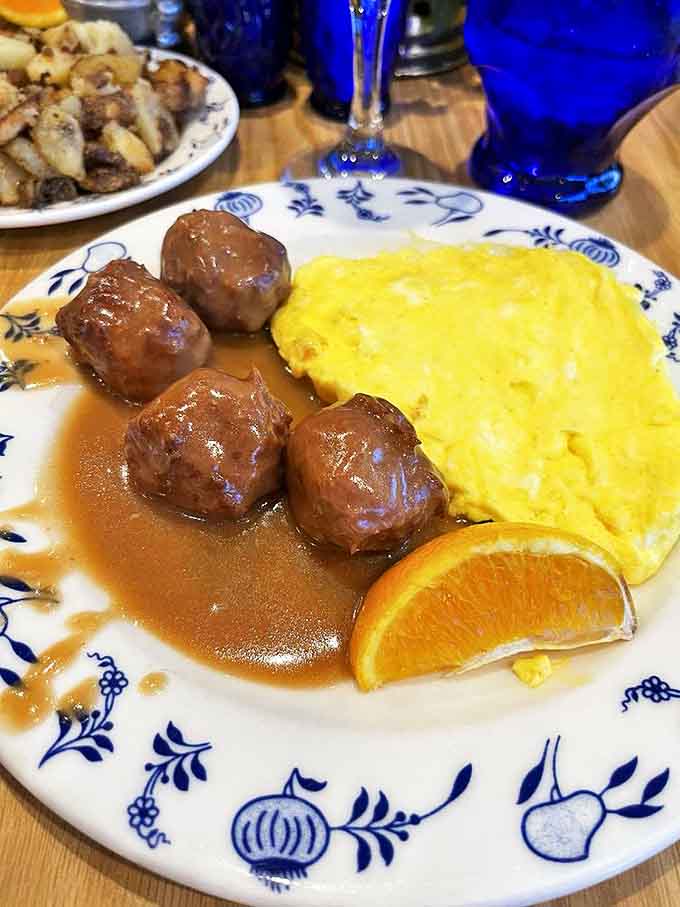 Scrambled eggs and Swedish meatballs: Breakfast of champions! Fluffy eggs alongside savory meatballs in gravy &ndash; morning fuel for roof-goat watching.