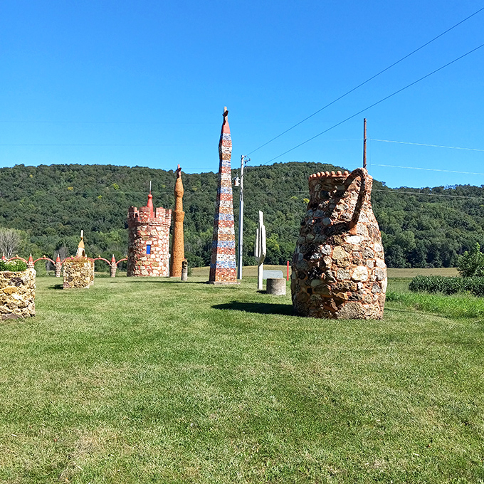 Stone sculptures stand in silent conversation across the grassy field, each with its own personality despite being made of the same materials.