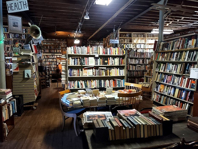 Narrow pathways between towering bookshelves create an intimate labyrinth where literary treasures await around every corner.