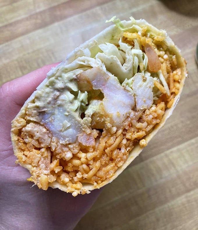 Plump shrimp nestled with crisp vegetables and rice create a seafood burrito that brings coastal Mexican flavors to landlocked Minnesota.
