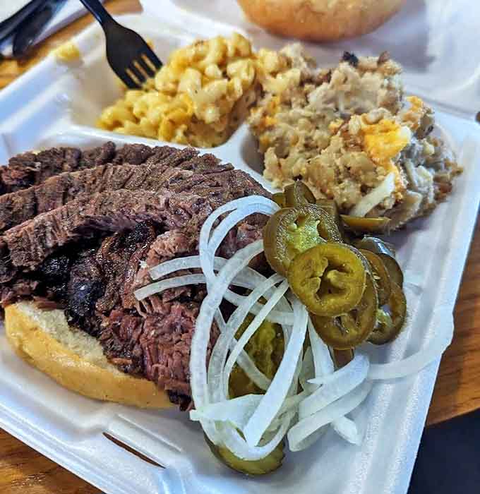 A Texas trinity of brisket, sides, and pickled accents creates a balanced plate that's both a feast for the eyes and stomach.
