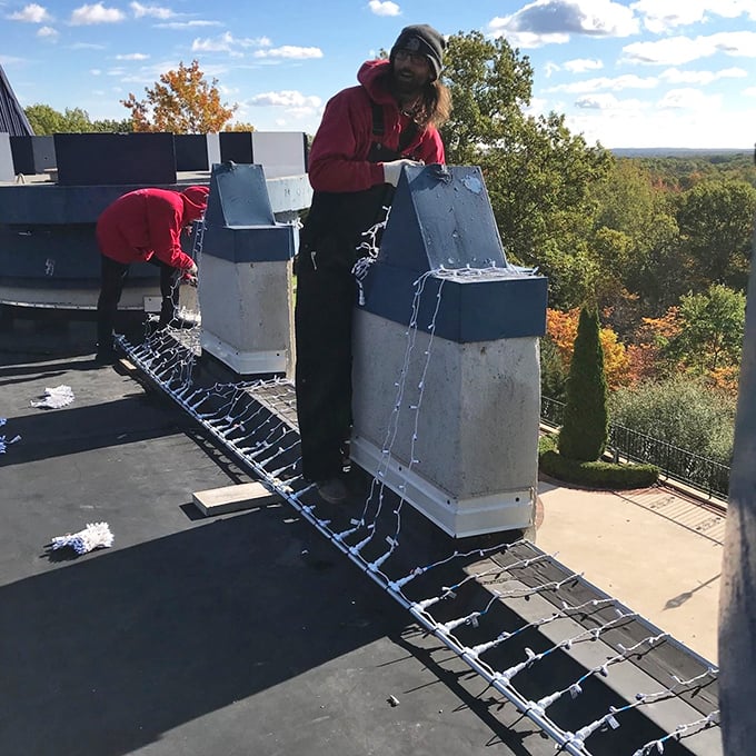 Dedicated staff work atop the castle's roof, ensuring every detail of this architectural marvel remains in pristine condition.