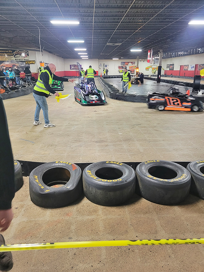 Track officials in safety vests monitor the action, ensuring both competitive racing and a secure environment for all drivers.