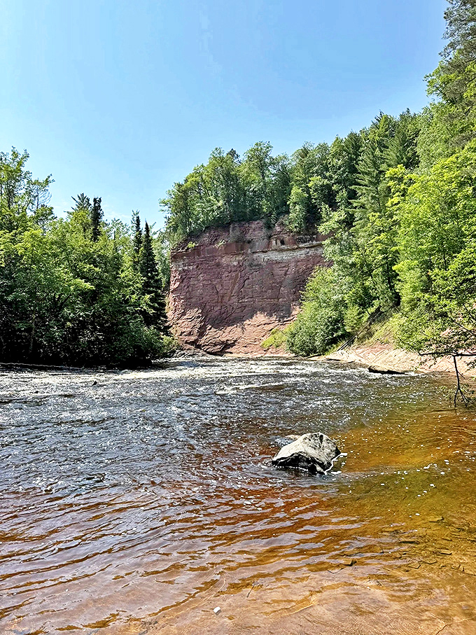 Ancient architecture: Towering sandstone cliffs stand as testament to geological forces that have shaped Michigan's rugged landscape for millennia.