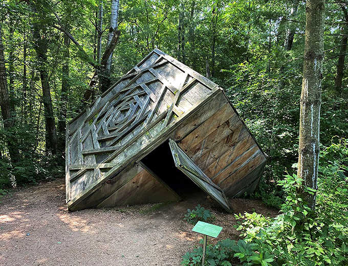 This collapsed wooden structure invites visitors to contemplate what remains when our carefully constructed worlds fall apart.