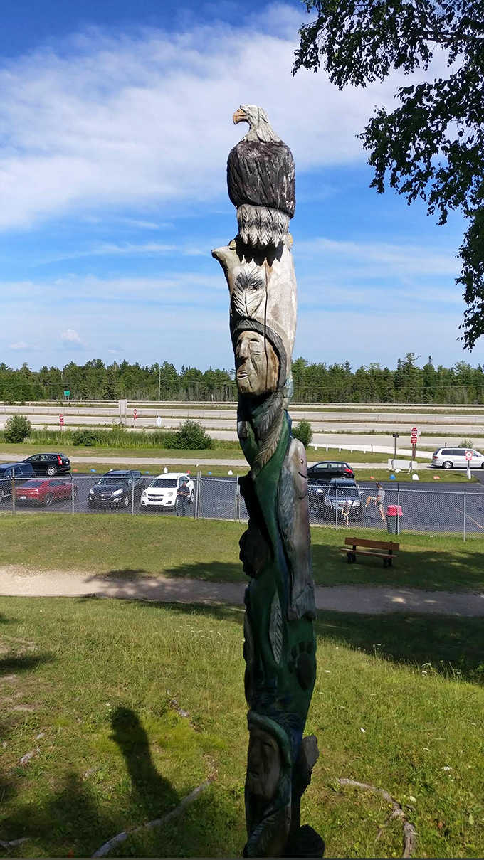 This carved totem pole adds artistic flair to the natural beauty, standing tall with stories carved into every inch.