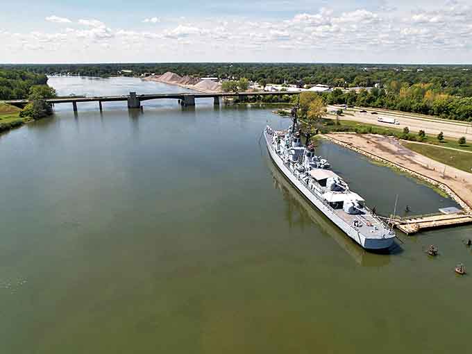 From above, the Edson's impressive silhouette cuts through the Saginaw River landscape, a steel island of history amid Michigan's natural beauty.