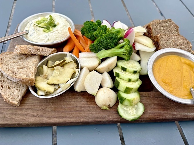 Garden-fresh vegetables arranged like a colorful mosaic, accompanied by house-made dips that transform raw produce into culinary magic.