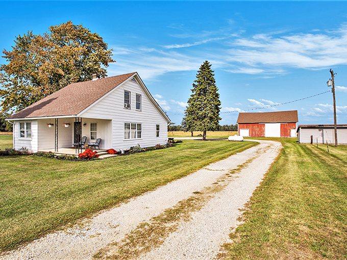 Classic farmhouses dot the landscape, their simple white clapboard telling stories of Midwestern resilience and agricultural tradition.