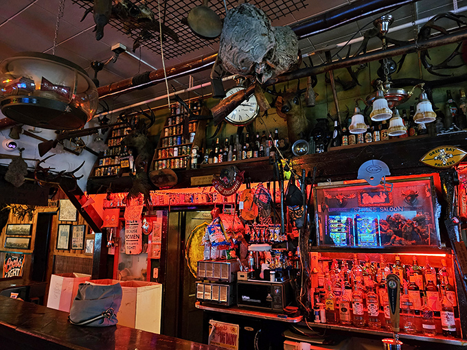 The bar itself is a masterpiece of organized chaos &ndash; bottles gleaming beneath mounted trophies and decades of collected memorabilia.