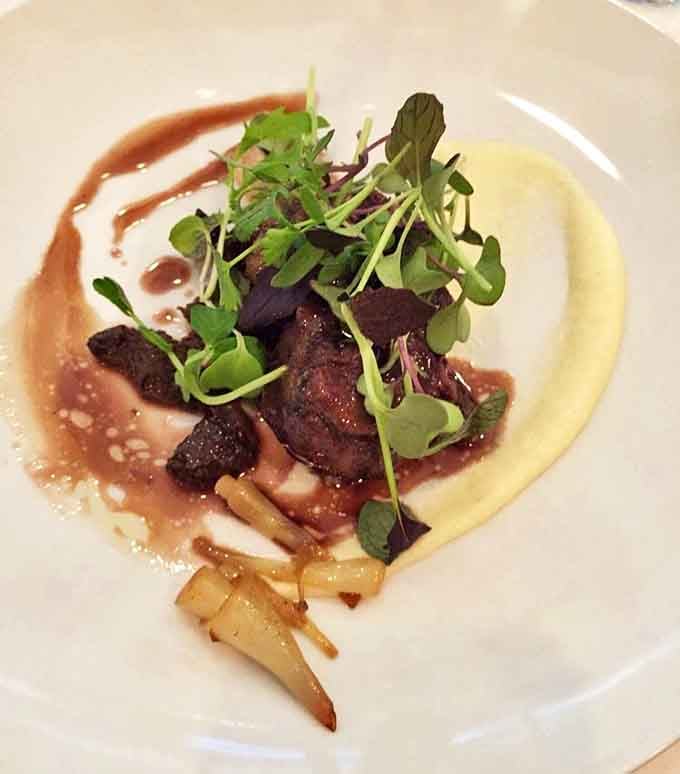 These braised beef cheeks aren't just tender, they're surrender-on-a-plate, nestled on creamy puree with a sauce worth bottling and taking home.