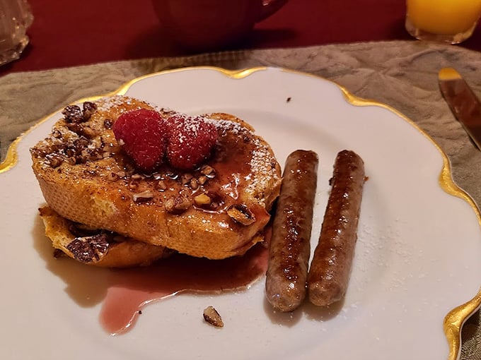 Breakfast worth waking up for: French toast topped with pecans and fresh berries alongside perfectly browned breakfast sausages.