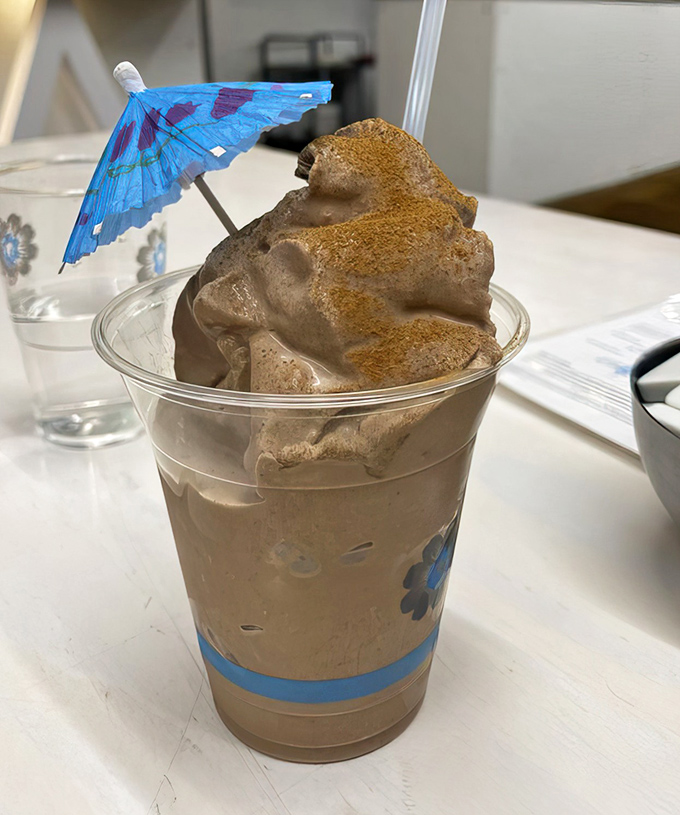 Chocolate batido topped with a tiny umbrella &ndash; because sometimes your dessert drink deserves a little parasol to shield it from your eager spoon.