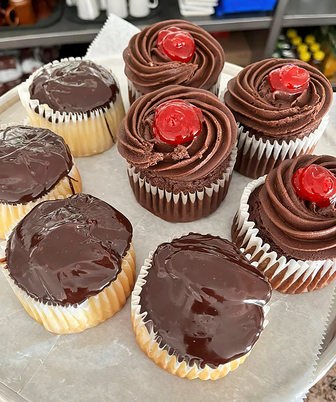 Chocolate cupcakes crowned with swirls of frosting and cherry jewels&mdash;tiny thrones for your taste buds.