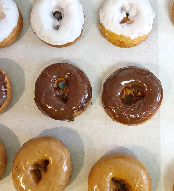 Morning temptations line up in sweet formation &ndash; glazed, chocolate-dipped, and caramel-coated donuts that make breakfast feel like a celebration.