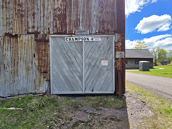The entrance to Champion #4 Copper Mine features distinctive stonework and brick detailing, a portal to underground networks that once buzzed with activity.