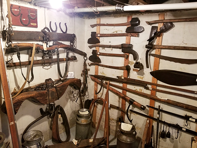Farm implements and tools line the walls of this display area, each worn handle telling stories of the physical labor that built this community.