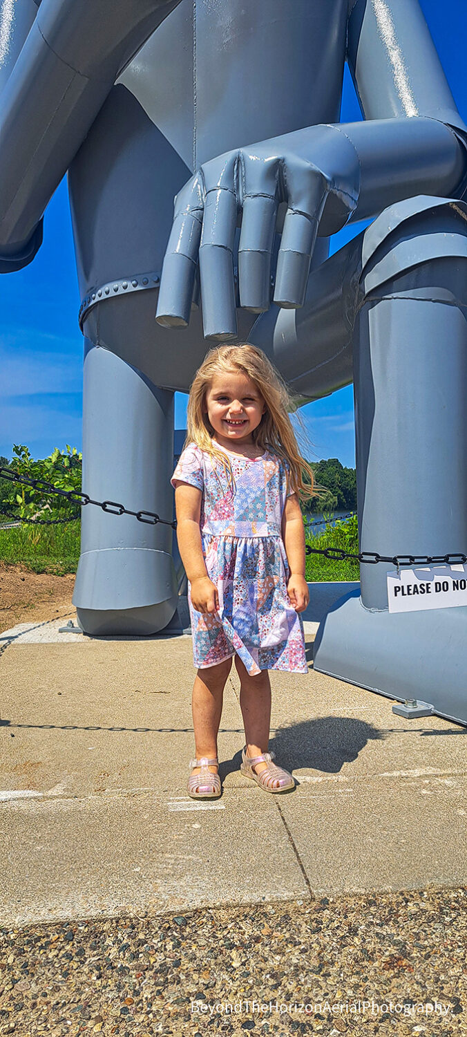 Children delight in standing beneath the gentle giant's massive frame, creating perspective photos that highlight his impressive scale.