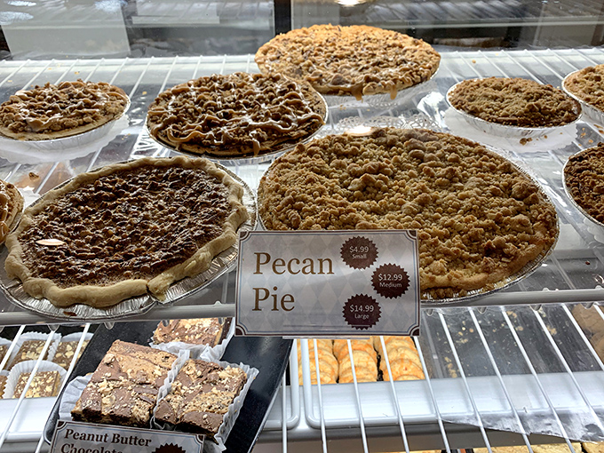 Pies lined up like delicious soldiers, each one ready to defeat your diet with flaky crust and perfect filling.