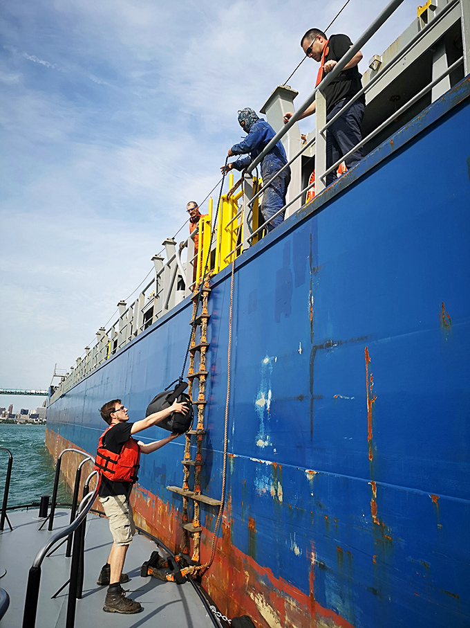 The original DoorDash! Crew members perform the delicate dance of transferring packages to massive ships that never stop moving.