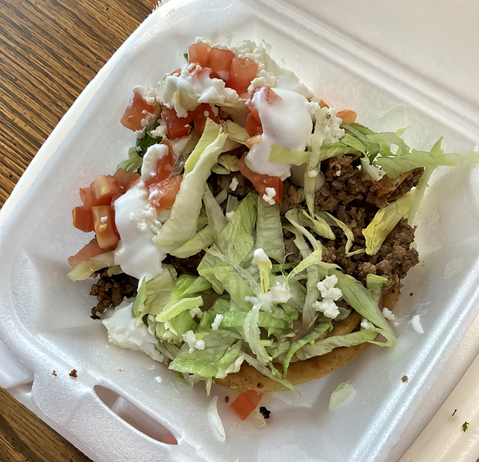 A sope loaded with toppings that proves sometimes the best things come on thick corn masa cakes.