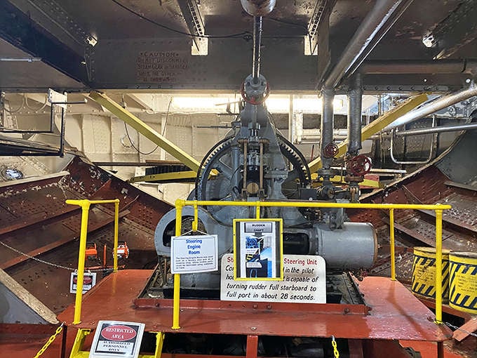 The steering engine room houses the mechanical heart that once turned the massive rudder. Every bolt and gear tells a story of industrial ingenuity.