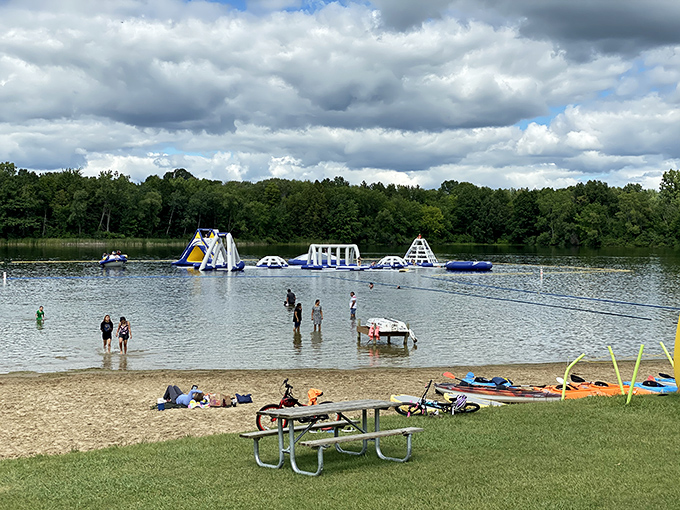 Beachgoers enjoy the perfect vantage point for watching aquatic acrobatics while gathering courage for their own watery challenges.