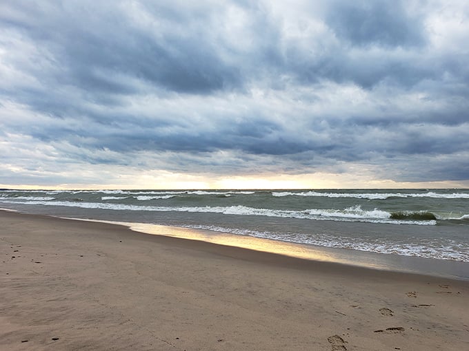 Moody skies create dramatic backdrops as waves roll in, perfect for contemplative beach walks and soul-searching.