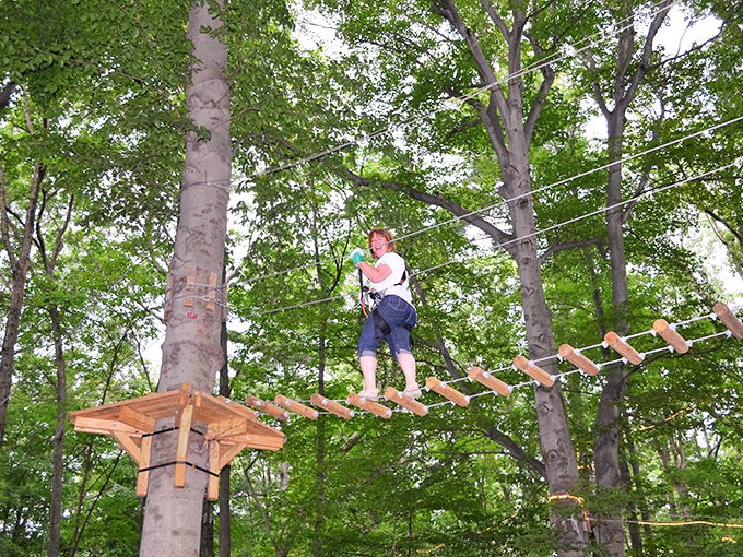 Each wobbly step is a negotiation between confidence and gravity, with safety cables providing the final vote.