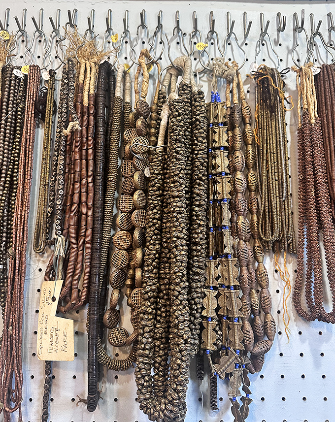 Ancient trade beads that once crossed oceans as currency now rest in careful displays, their rich browns and earthy patterns revealing craftsmanship that transcends time.