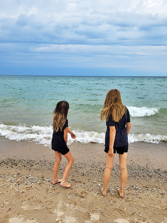 Young explorers discover the simple joy of wading into Lake Huron's clear waters, where every step brings a new aquatic adventure.