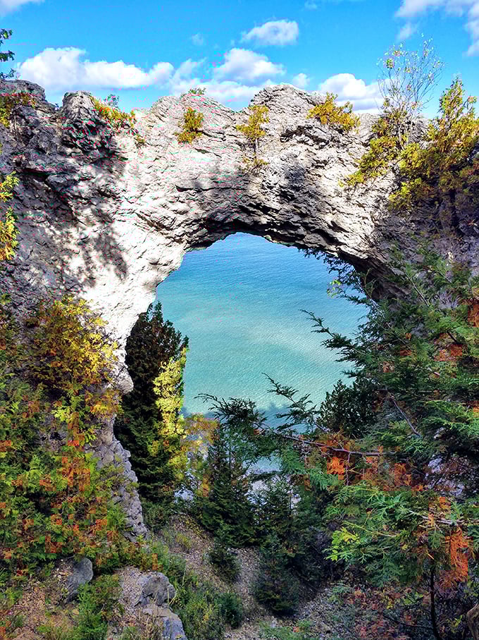 Arch Rock frames Lake Huron's azure waters like nature's own masterpiece, a limestone gateway formed over millennia that no human architect could improve upon.