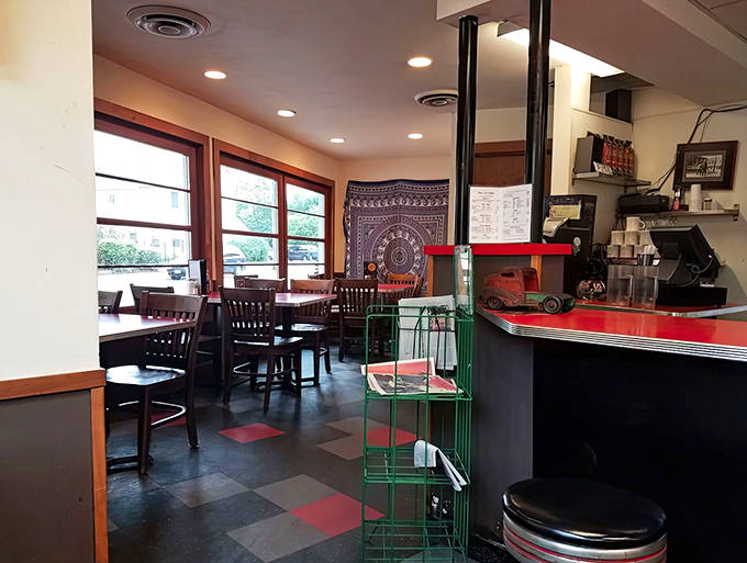 The diner's compact interior makes every inch count, with the black and white checkered floor creating the backdrop for countless Minneapolis memories.