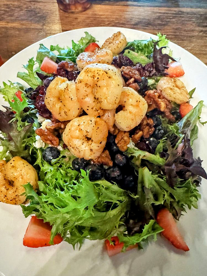 A garden-fresh salad topped with perfectly seasoned shrimp, candied walnuts, and berries offers a lighter option that doesn't sacrifice an ounce of flavor.