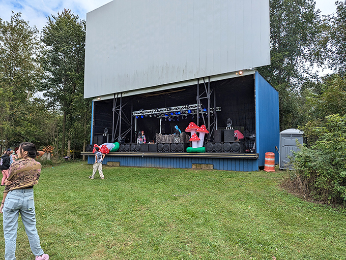 The massive screen towers over its domain, a beacon of entertainment that draws people from miles around to share in its glow.
