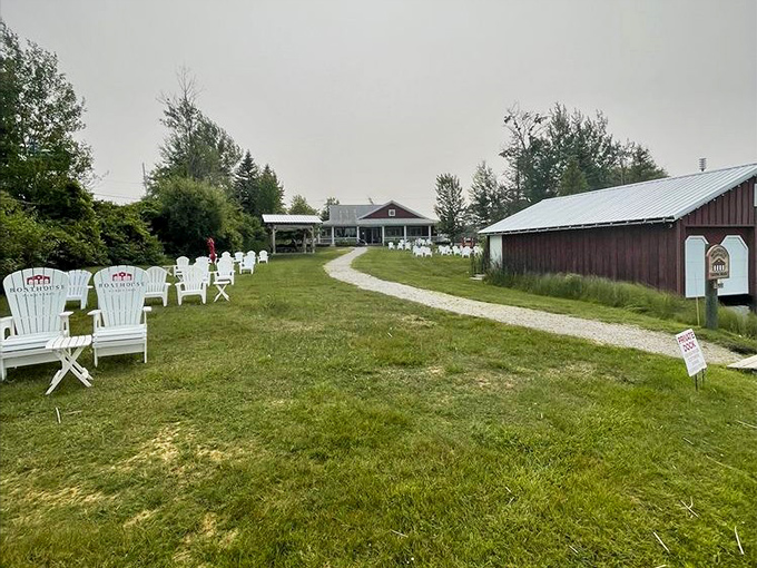 White Adirondack chairs invite visitors to pause along the winding path between tasting room and boathouse &ndash; Michigan's version of meditation stations.